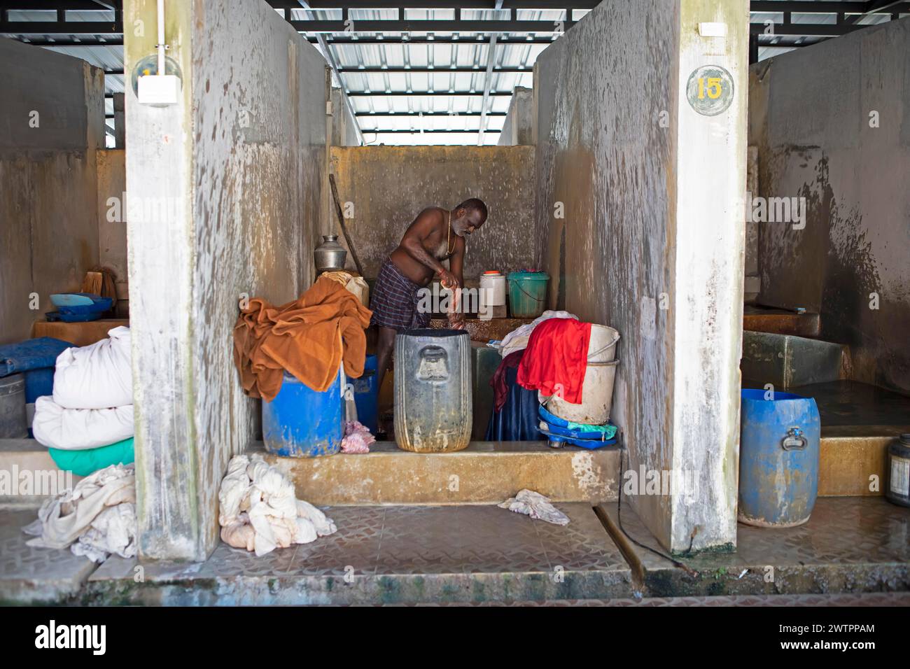 Indian man washing clothes in the laundry Dhoby Khana, Kochi, Kerala ...