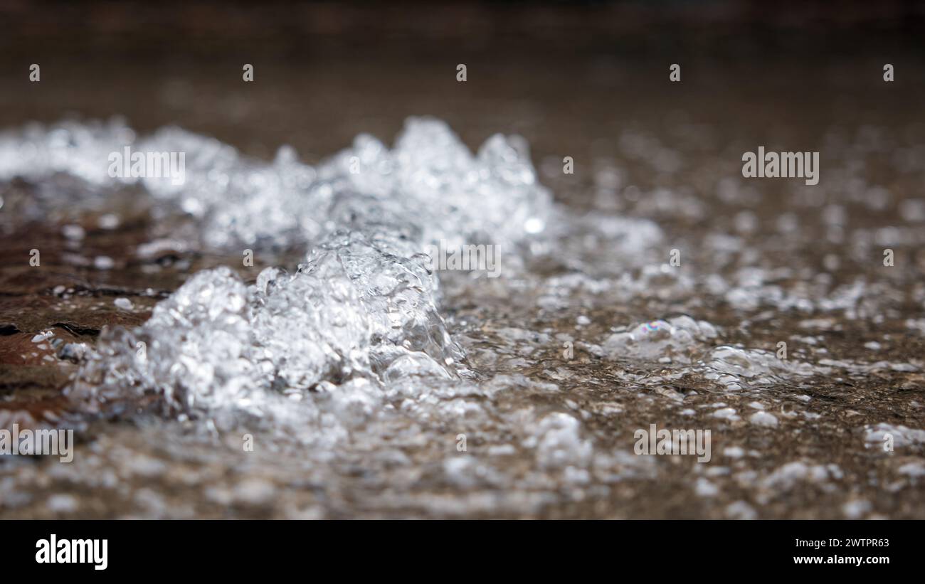 Water pipe burst, water Water flows out of the manhole onto the asphalt ...