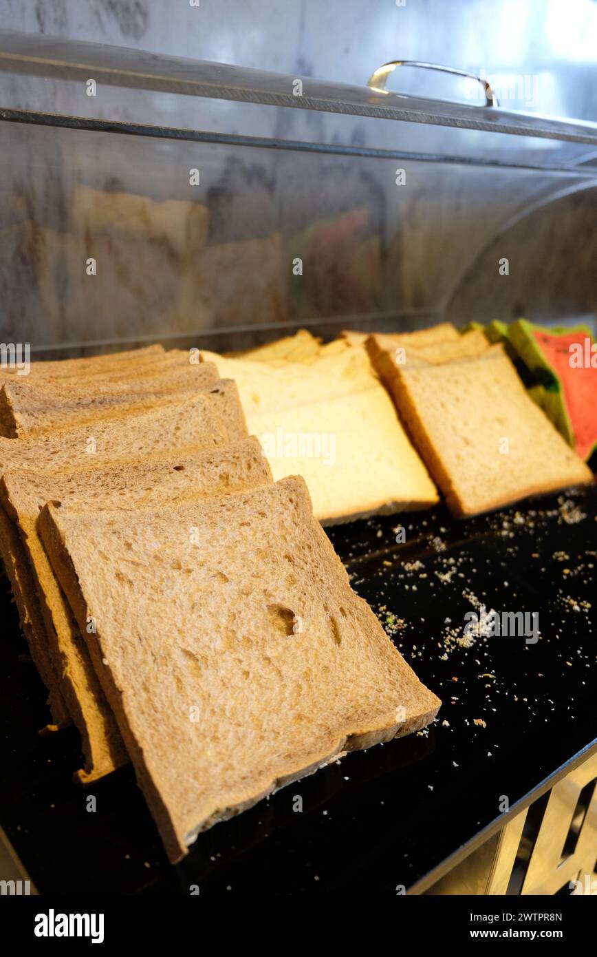 Tasty breakfast toasts on bread bin. Set of sliced toast bread slices ...