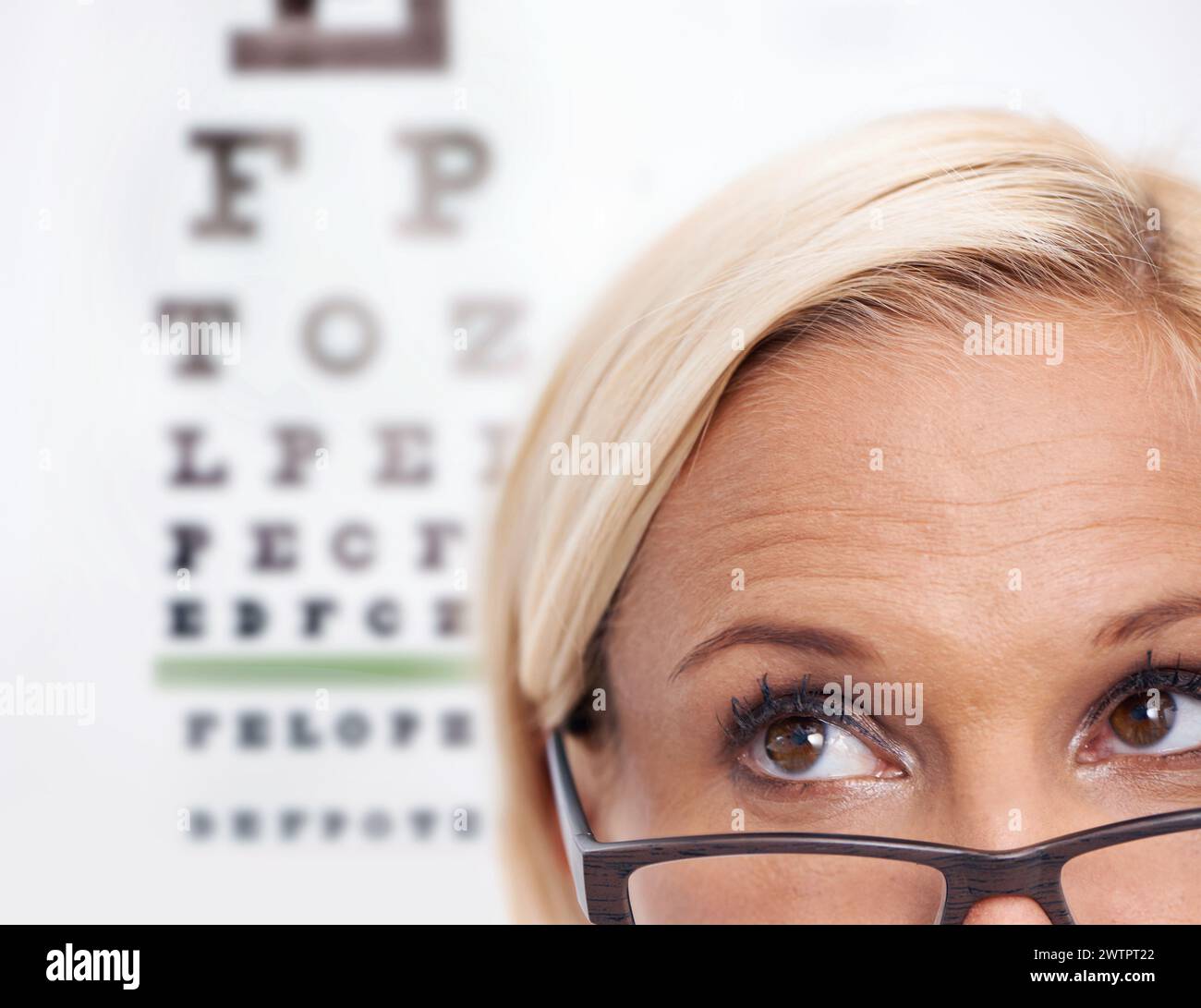 Woman, glasses and reading of chart for eye test, wellness and frame in ...