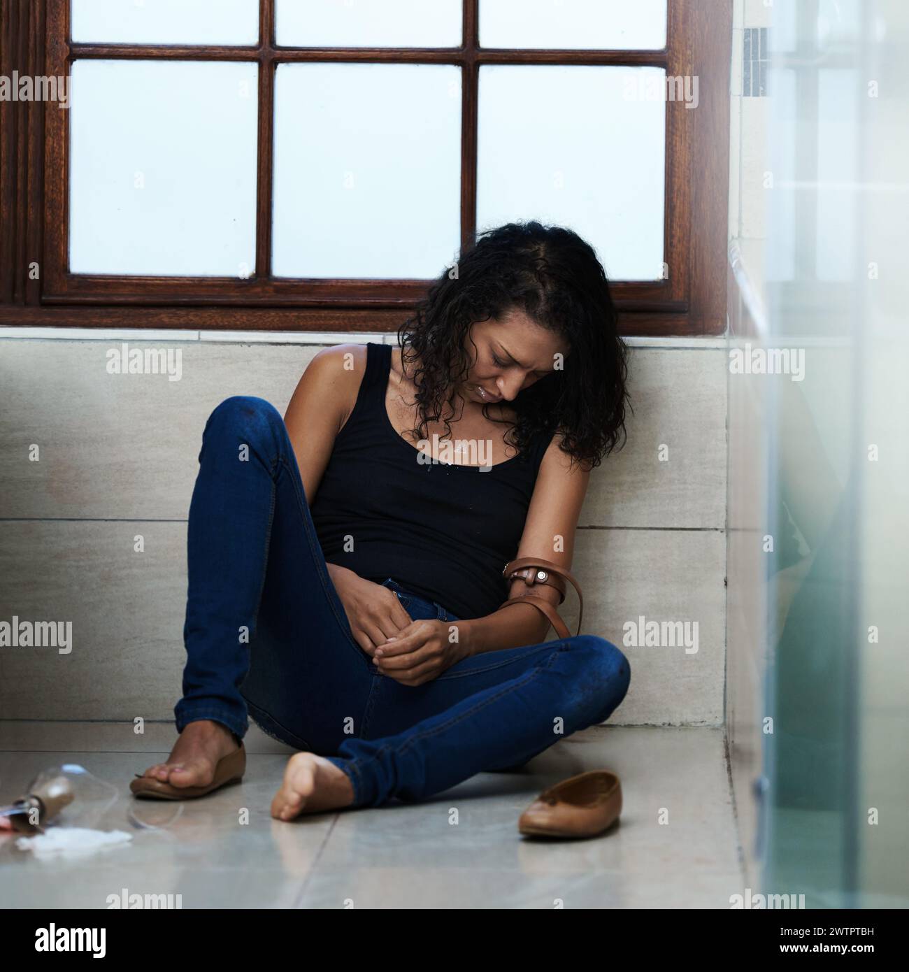 Woman, drug addict and overdose in bathroom for addiction or withdrawal ...