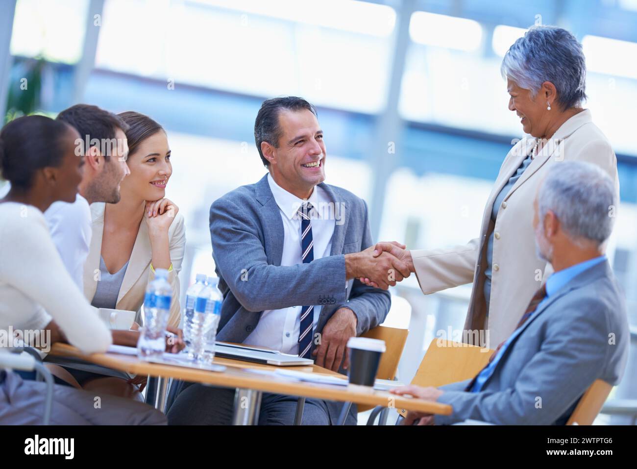 Coworker, office and handshake with smile for success on deal, teamwork ...