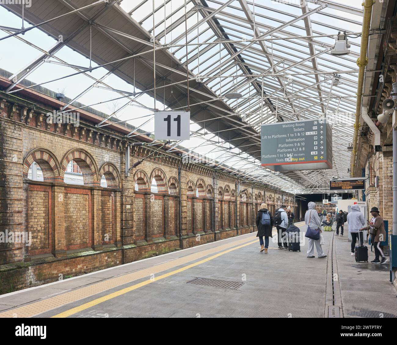 Passengers wait for a train on number 11 platform at the railway ...
