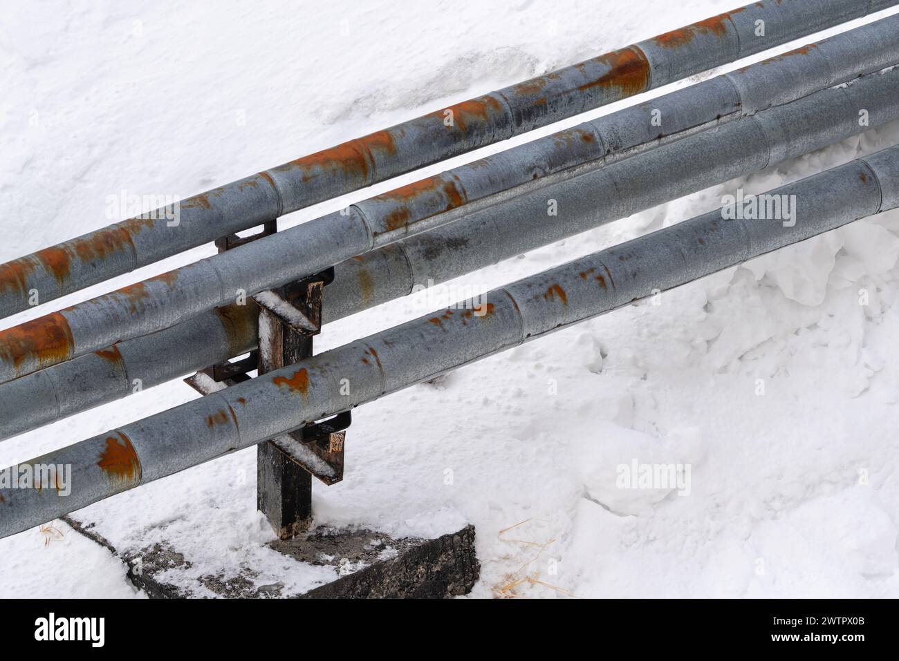 External city central heating pipes protruding from snow. Pipes in old ...