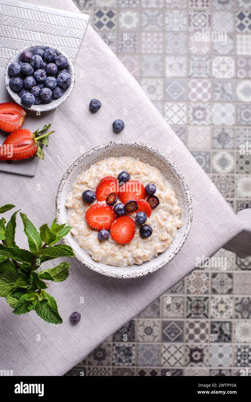 oatmeal porridge with strawberries blueberries and honey Stock Photo ...