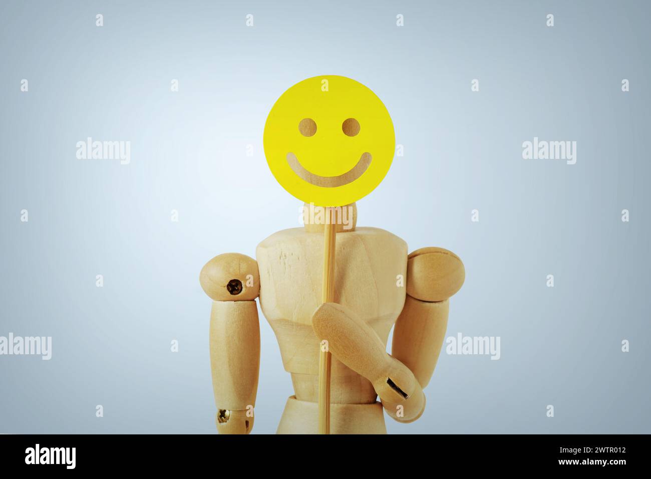 Wooden mannequin with happy face paddle - Concept of happiness, fun and ...