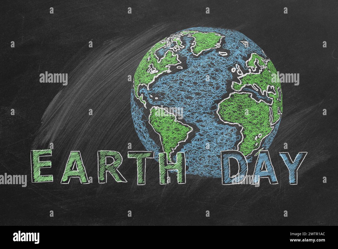 The world with lettering EARTH DAY hand drawn in chalk on a school ...