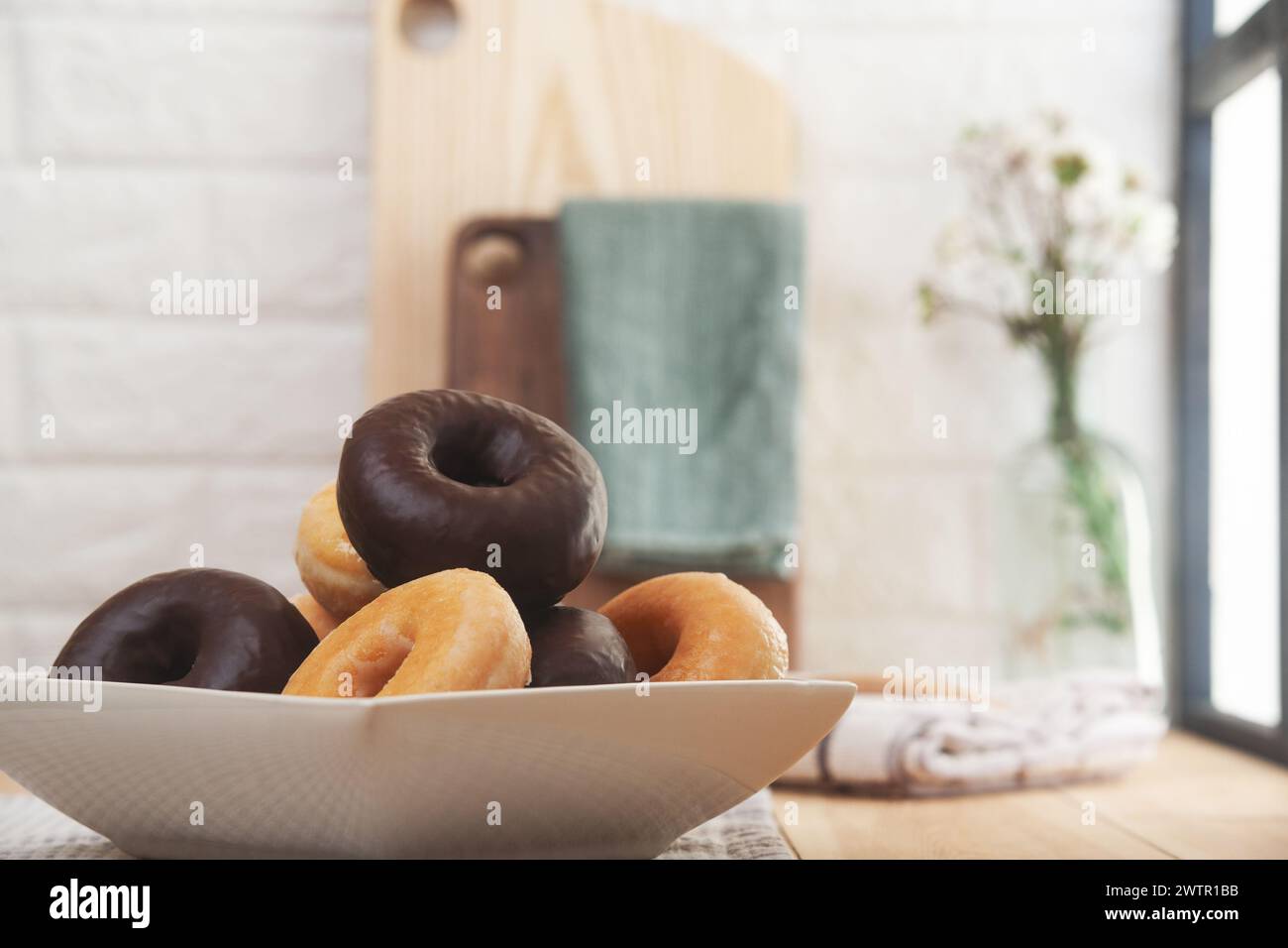 Horizontal shot of a plate of doughnuts with the out-of-focus ...