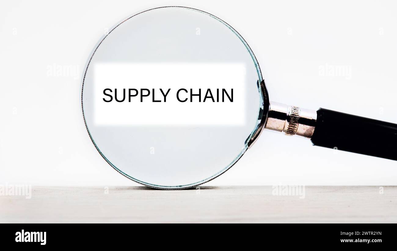 The words Supply Chain written through a magnifying glass on a white ...