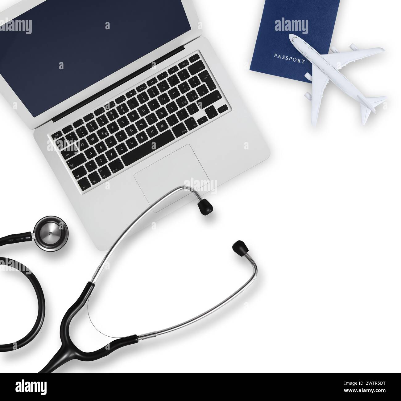 Top view of passport with airplane, computer and a stethoscope isolated ...