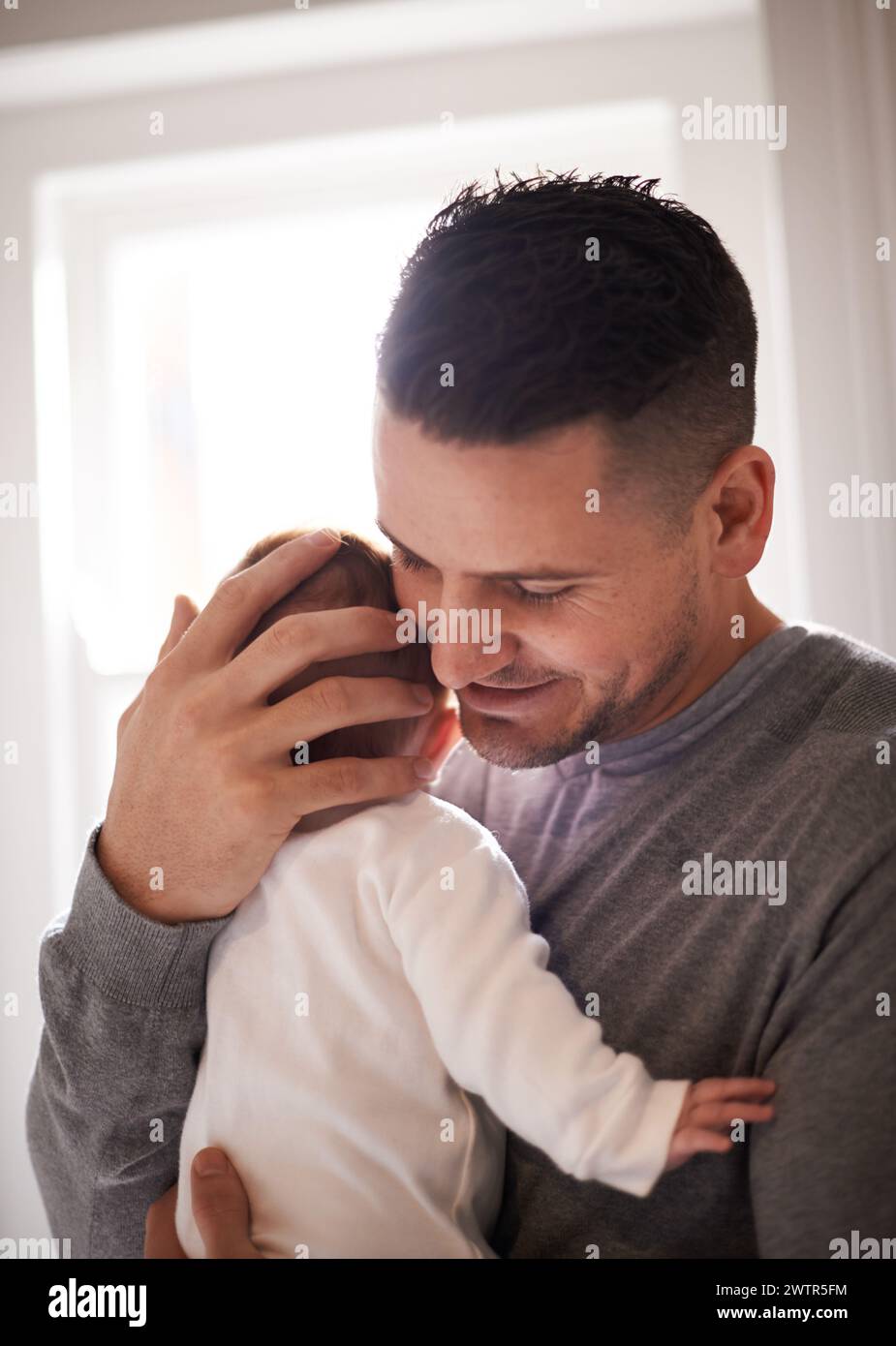 Dad, baby and pride with hug for bonding, love and happiness with child ...