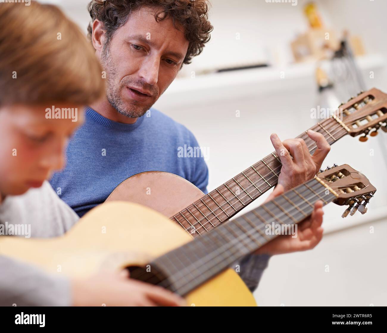 Learning, guitar and teacher in music with child in lesson and ...