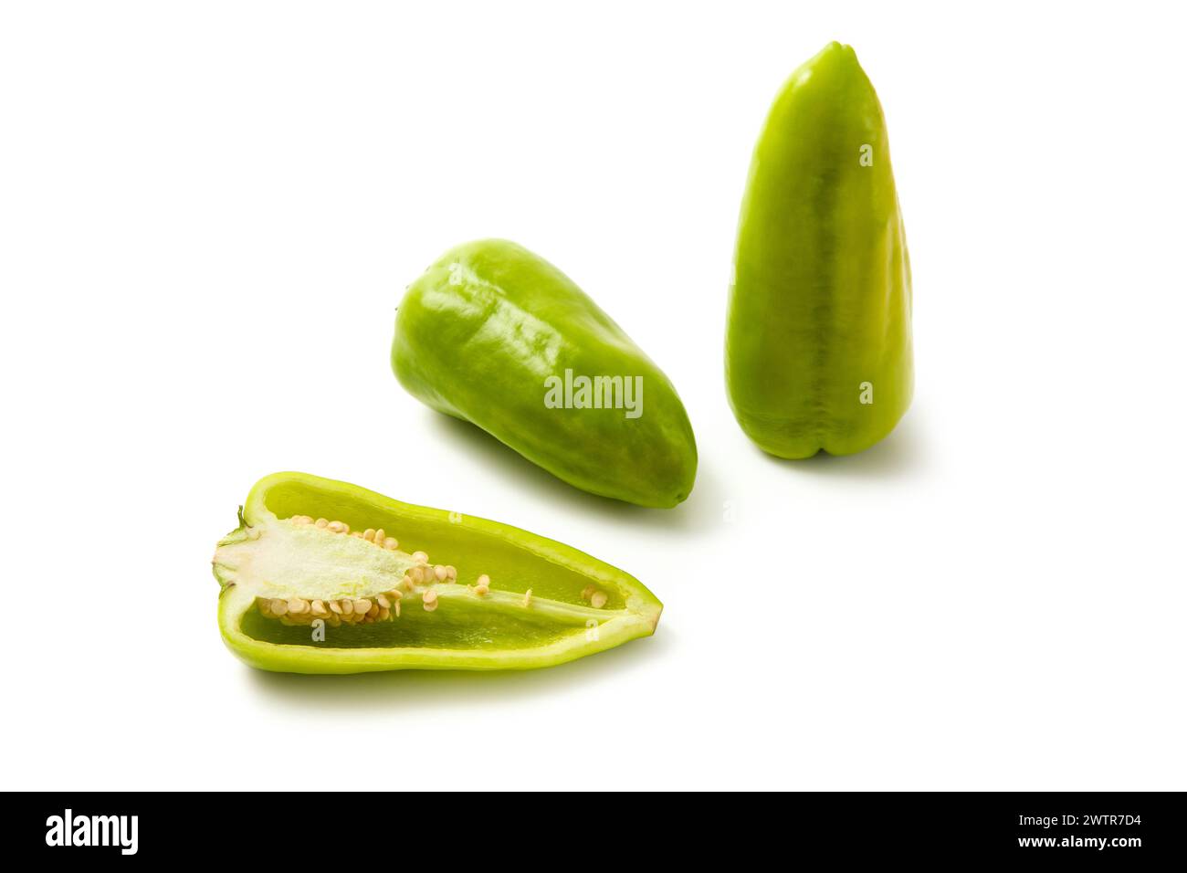 Two whole and half of green bell pepper (capsicum) known as sweet bell ...