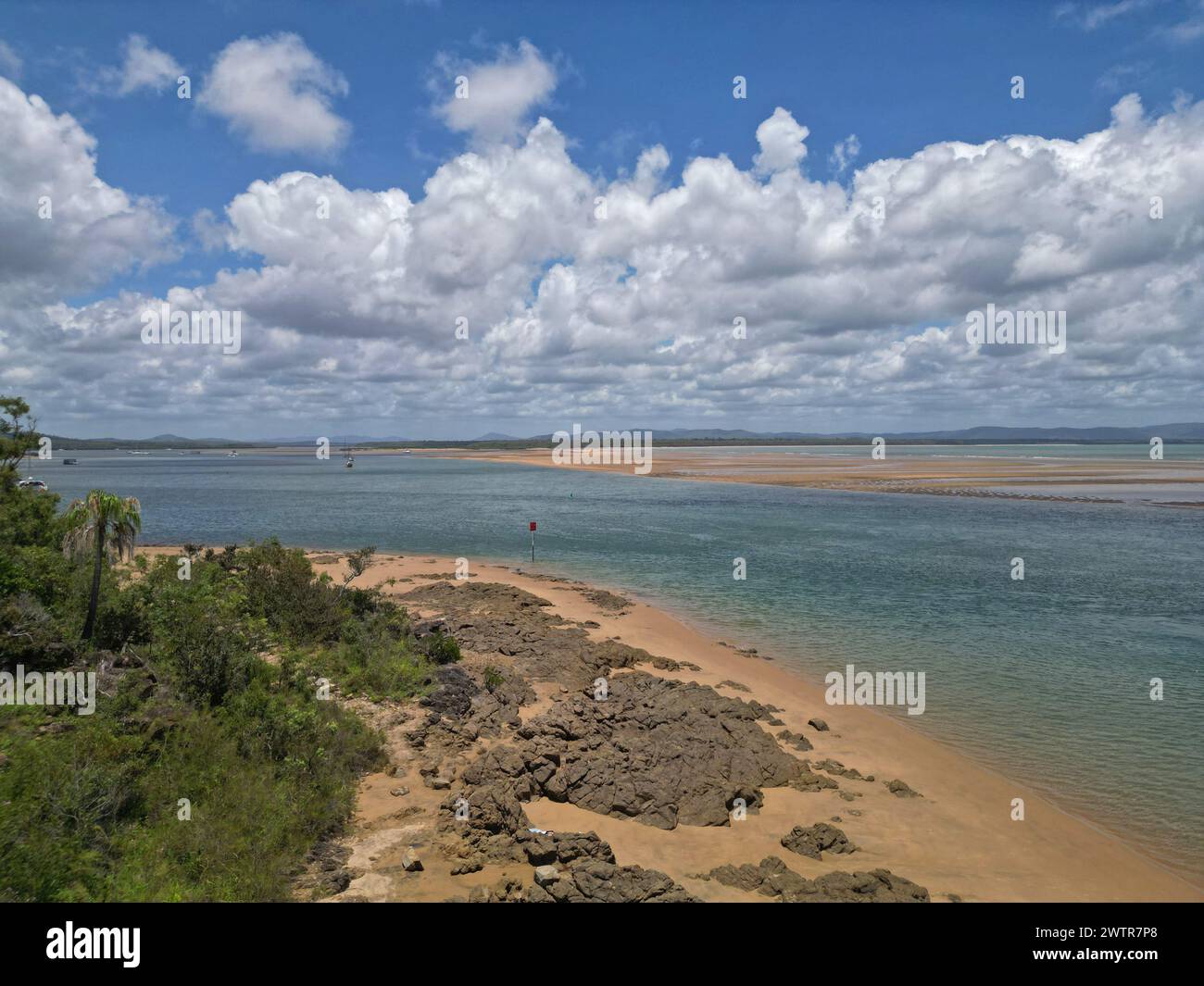A Sandy lakeside beach in a forested setting with water: Captain Cook's ...