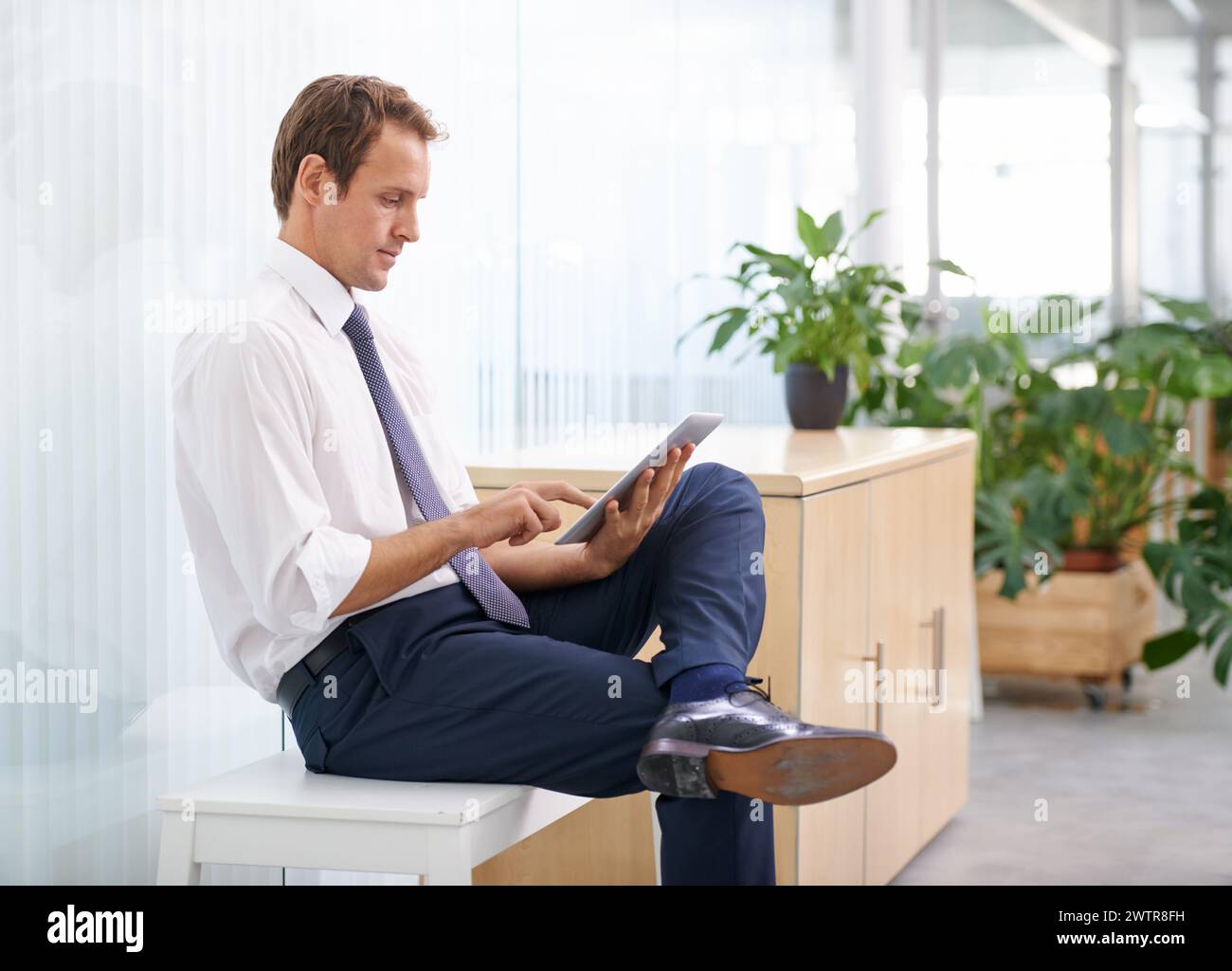 Businessman tablet scroll review hi-res stock photography and images ...