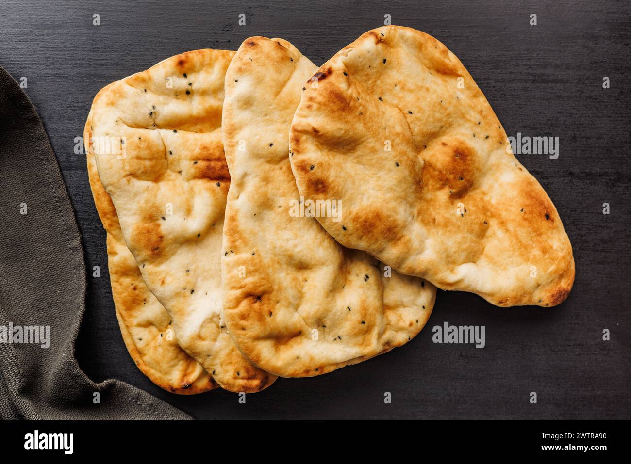 Three pieces of naan with a golden brown surface, ready to be served ...