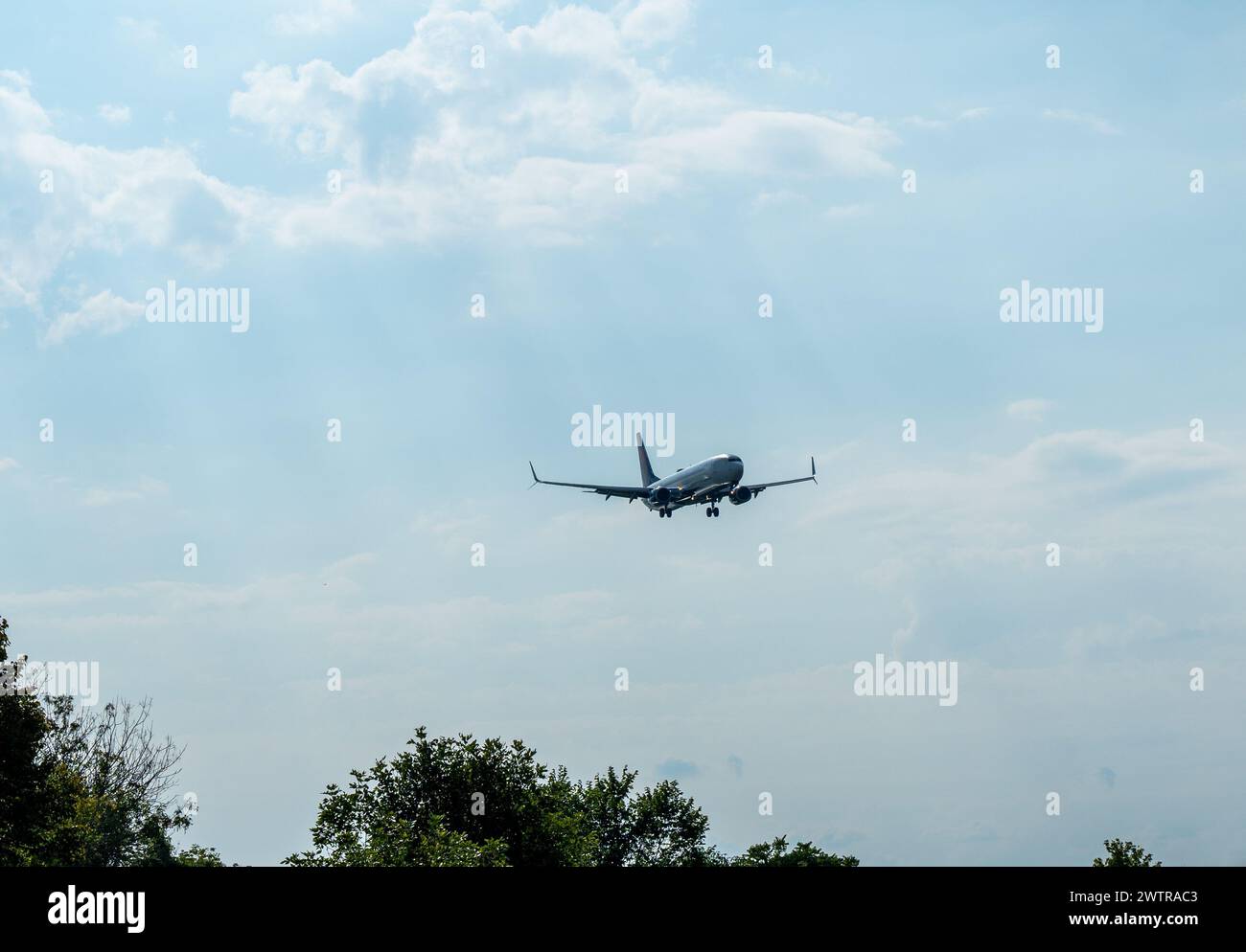 An airplane coming in for landing at an airport Stock Photo - Alamy