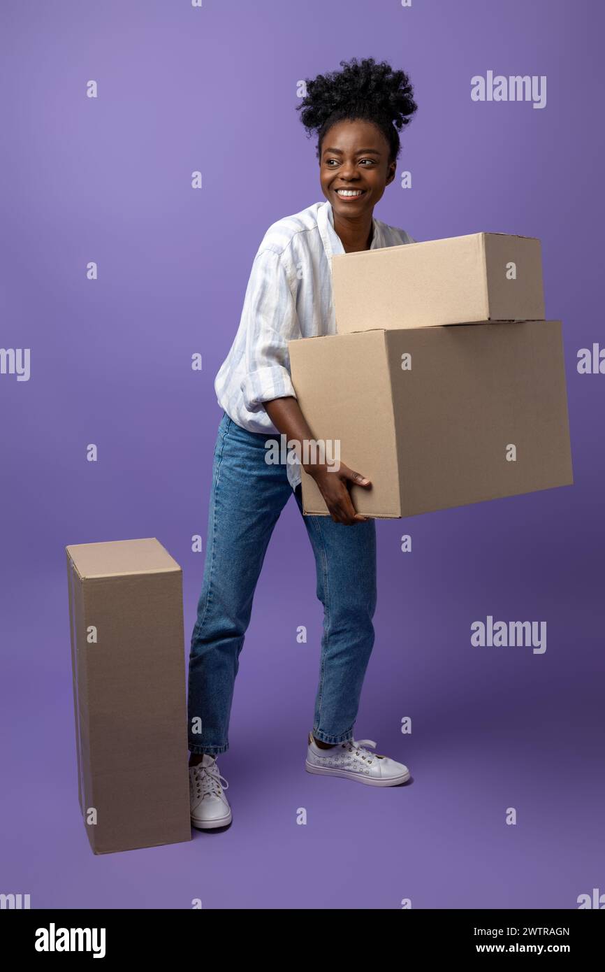 African american curly-haired girl with boxes on a violet background ...