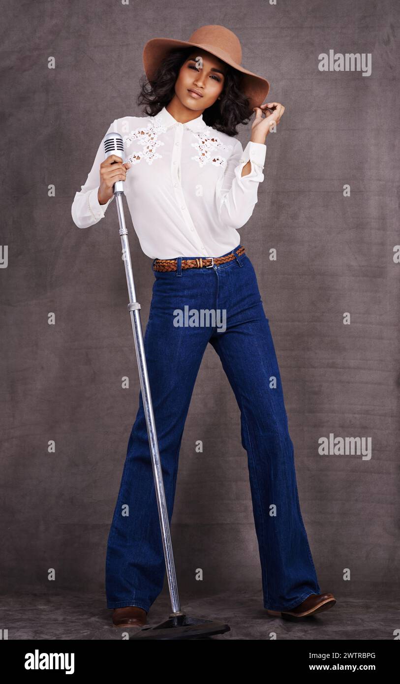 Woman, fashion and cowgirl in studio, microphone and western clothes on ...