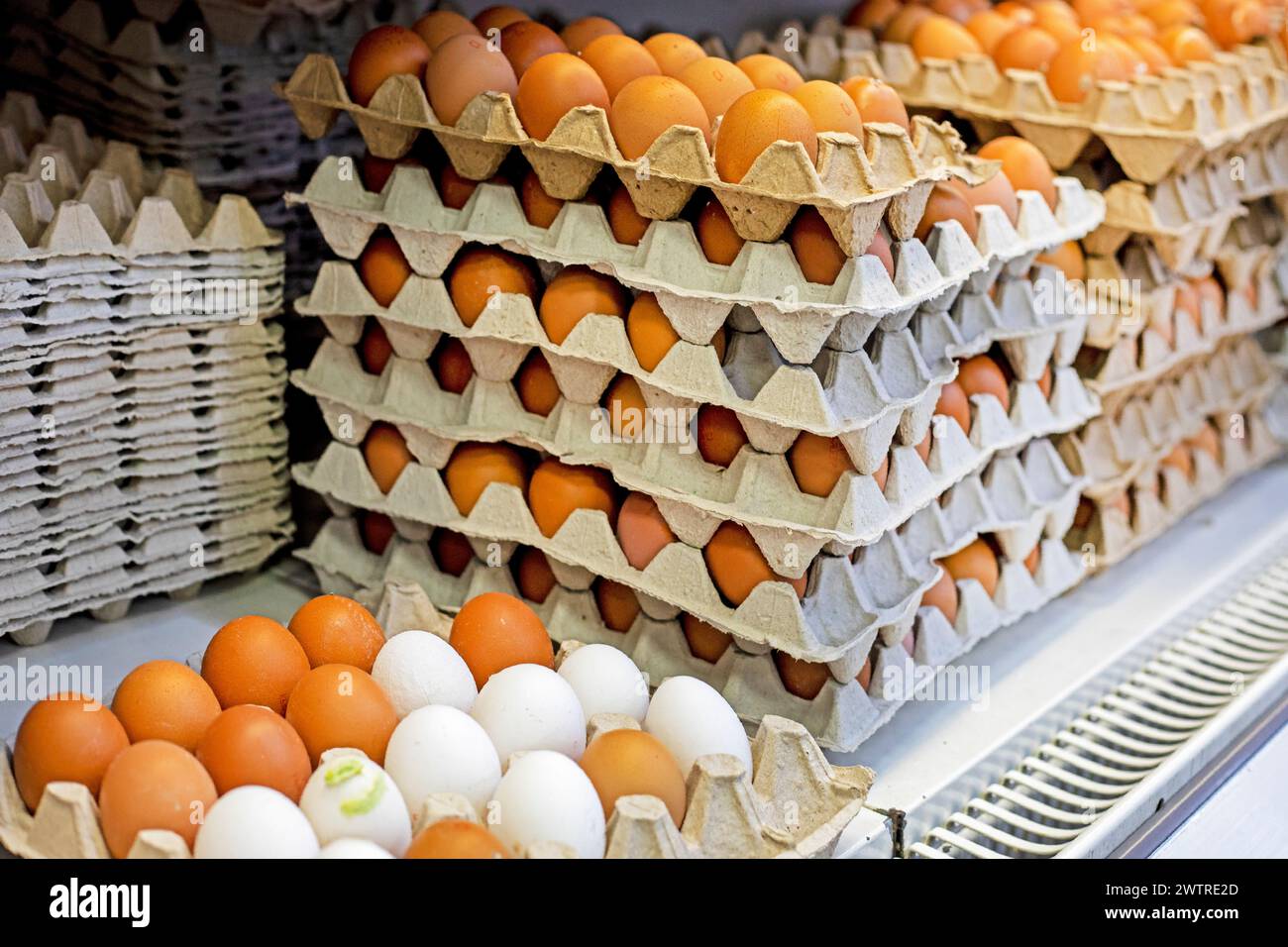 close-up of farm brown chicken eggs in cardboard containers on a store ...