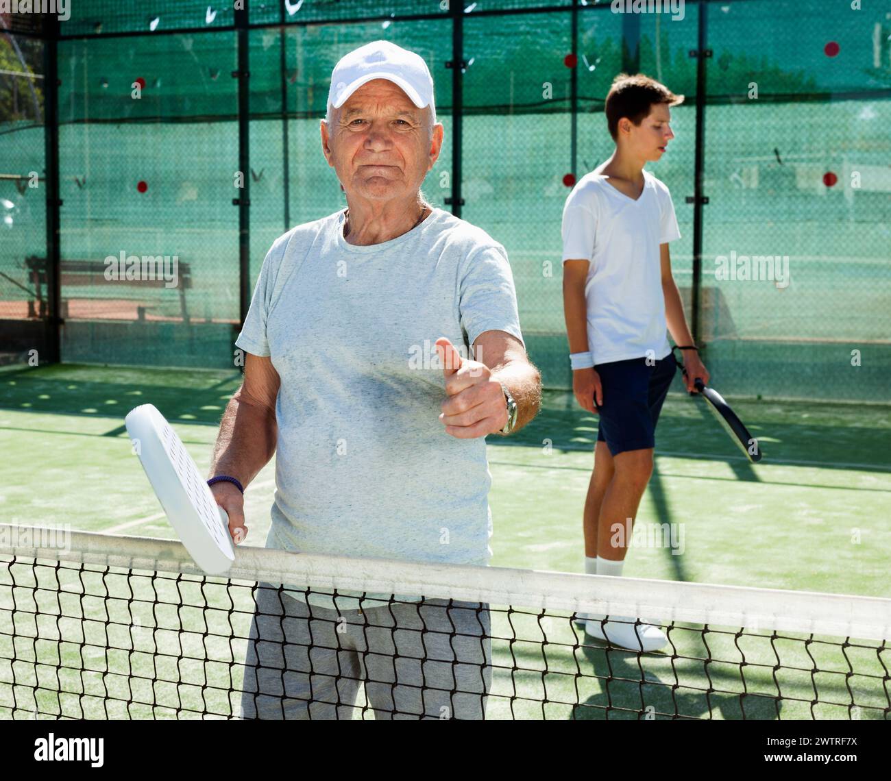 Padel players of different generations posing on padel court Stock ...