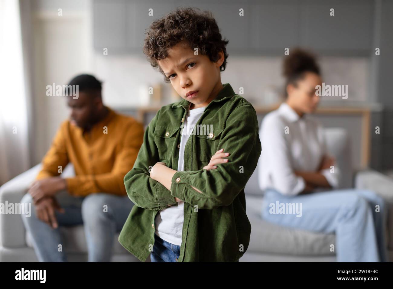 Child upset with parents arguing in background Stock Photo - Alamy