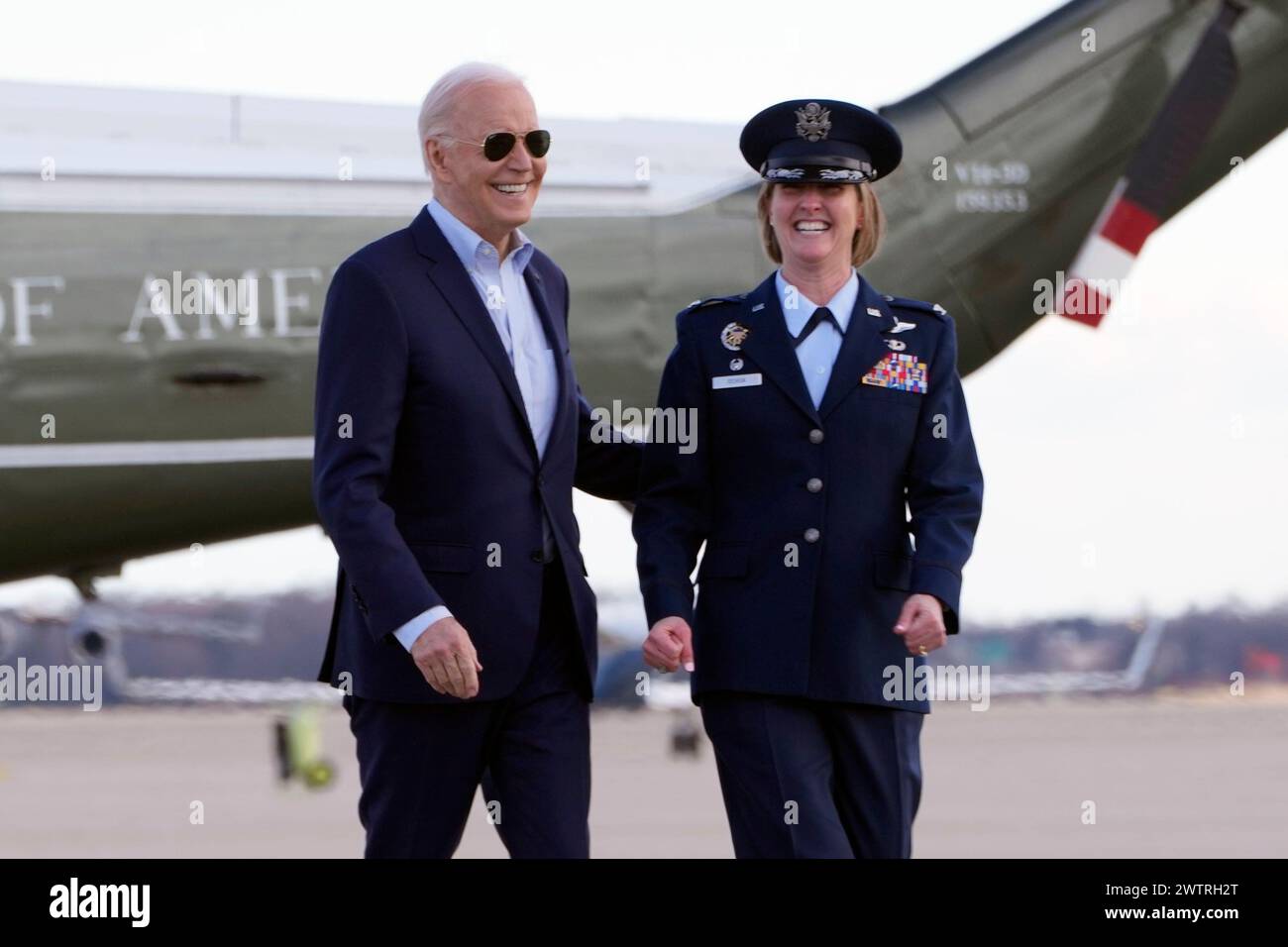 President Joe Biden, escorted by Col. Angela Ochoa, commander of the ...