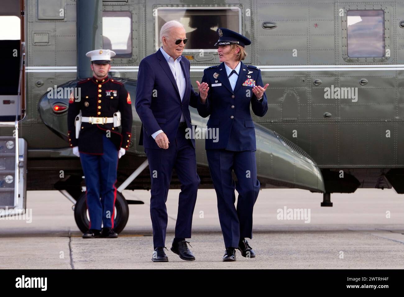 President Joe Biden, escorted by Col. Angela Ochoa, commander of the ...