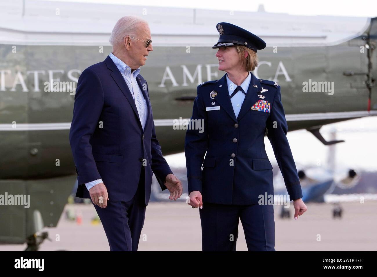 President Joe Biden, escorted by Col. Angela Ochoa, commander of the ...