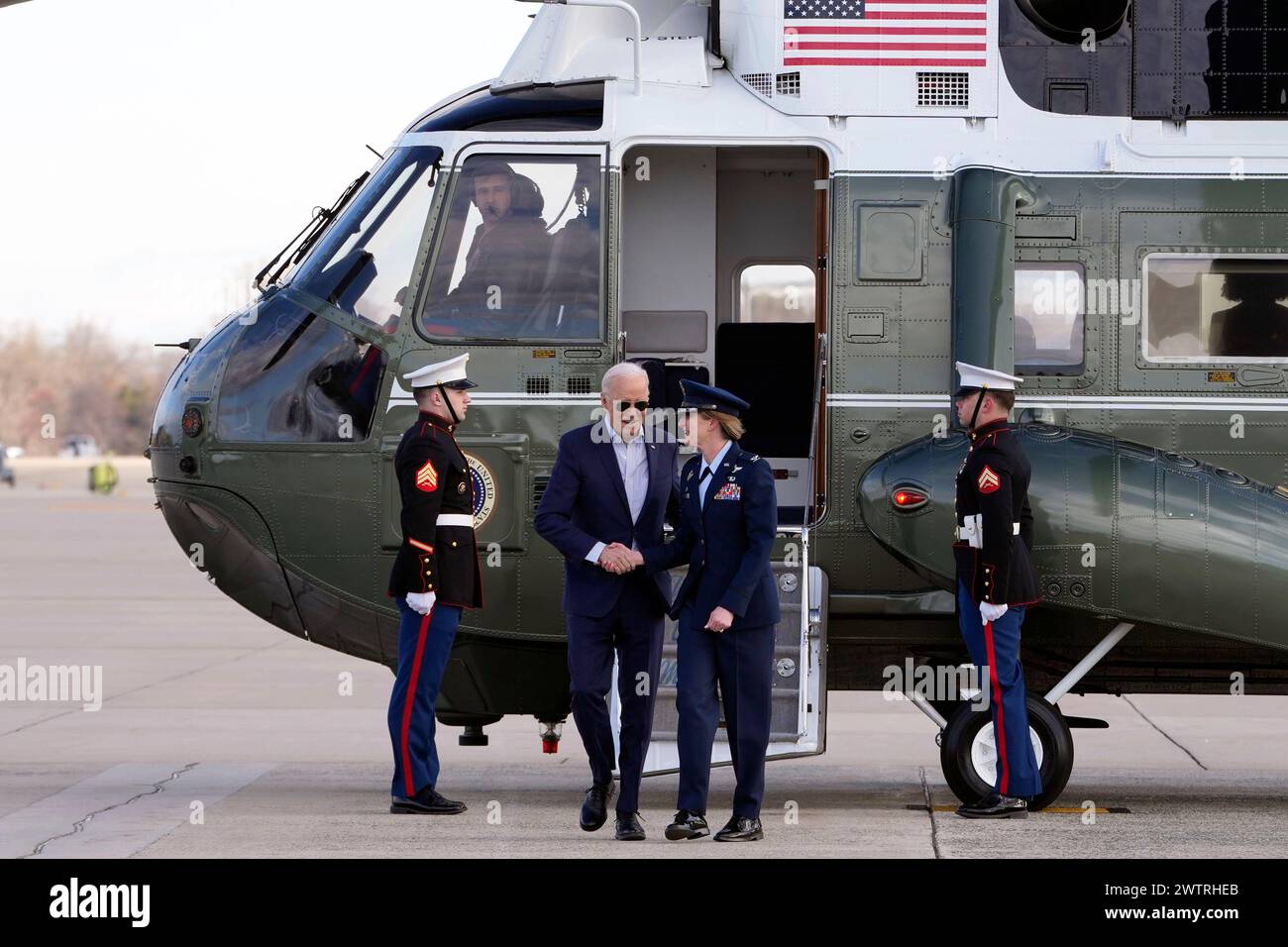 President Joe Biden, escorted by Col. Angela Ochoa, commander of the ...