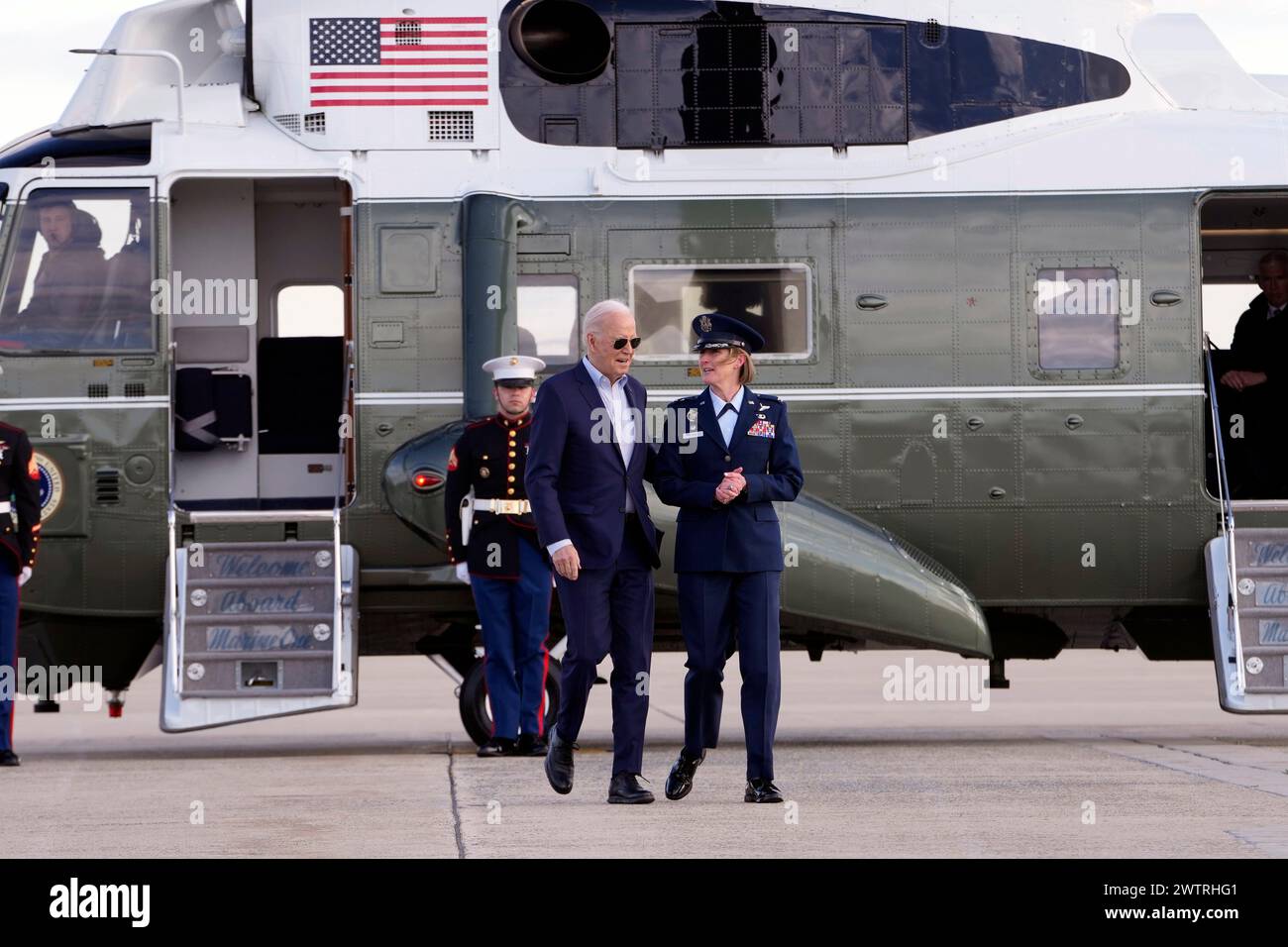 President Joe Biden, escorted by Col. Angela Ochoa, commander of the ...