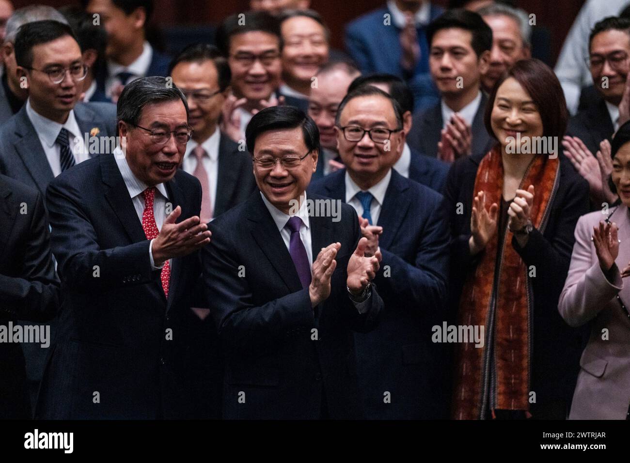 Hong Kong's Chief Executive John Lee Ka-chiu applauds with lawmakers ...