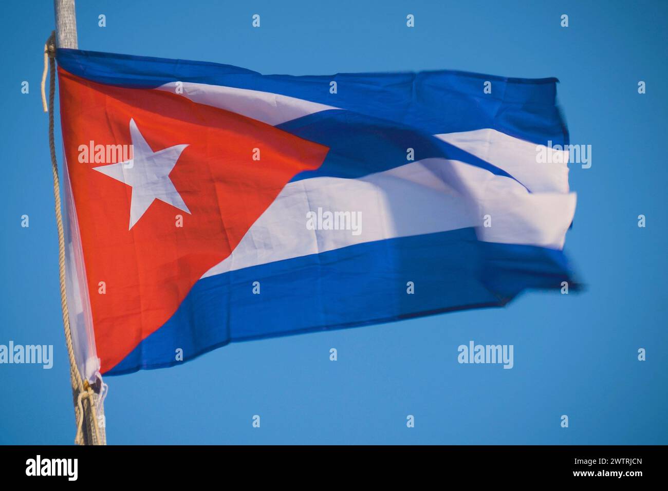 Cuban flag flying in the wind on a backdrop of blue sky. National ...