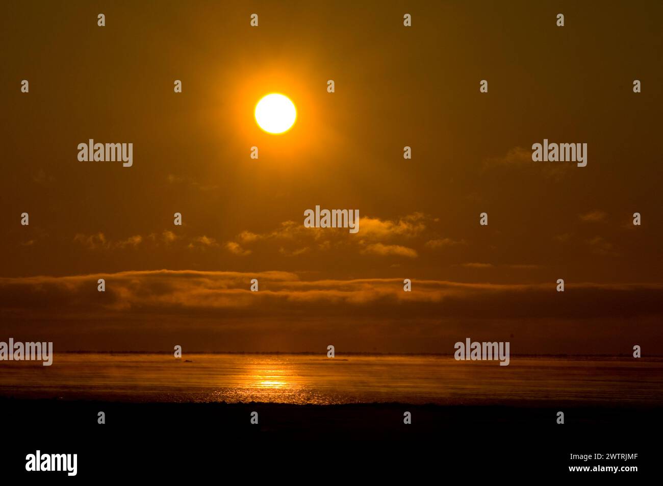 Seascape of sunset over open lead rough pack ice over the Chukchi sea ...