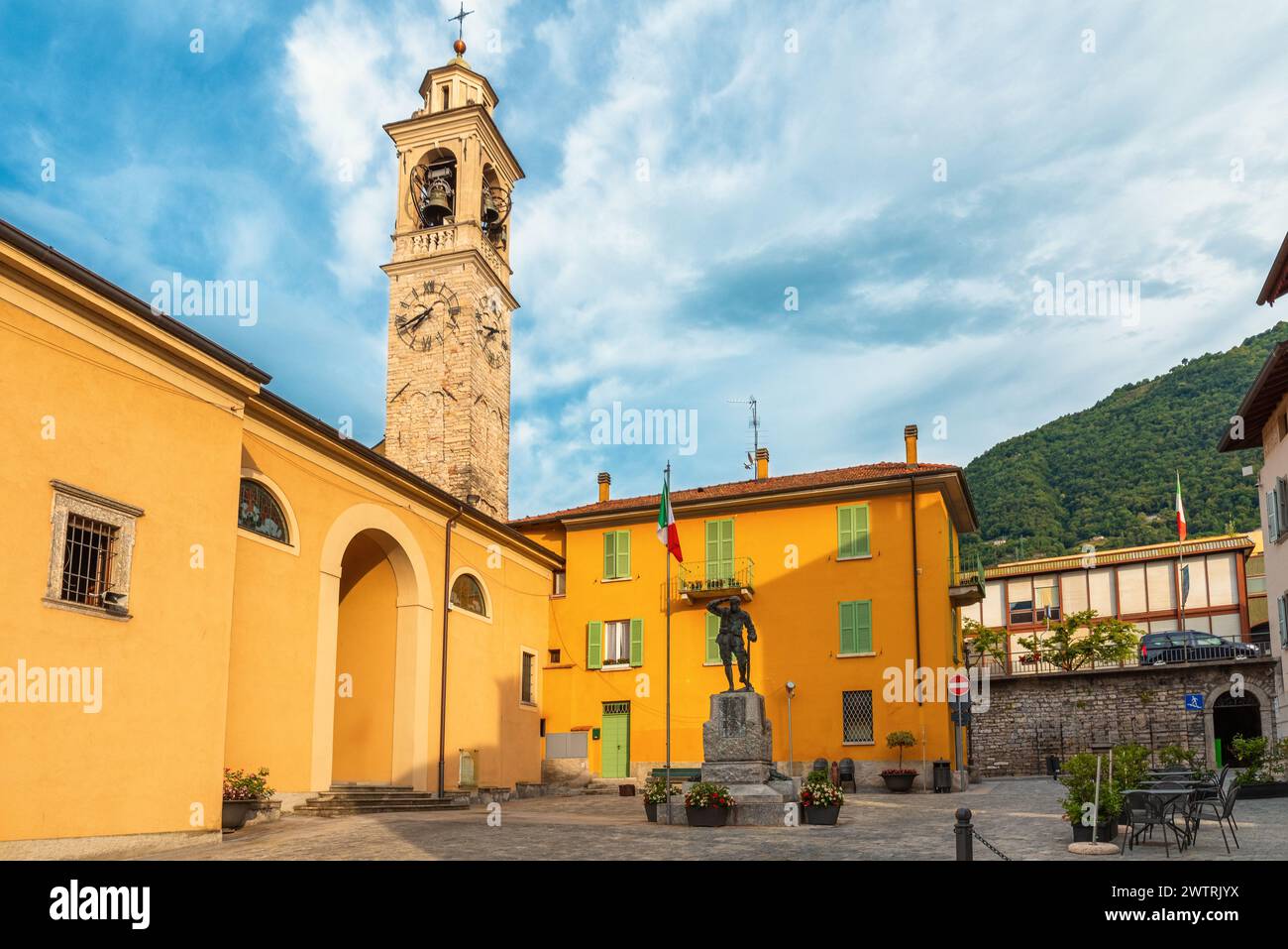 Medieval town square with church Chiesa Santo Stefano and colorful ...