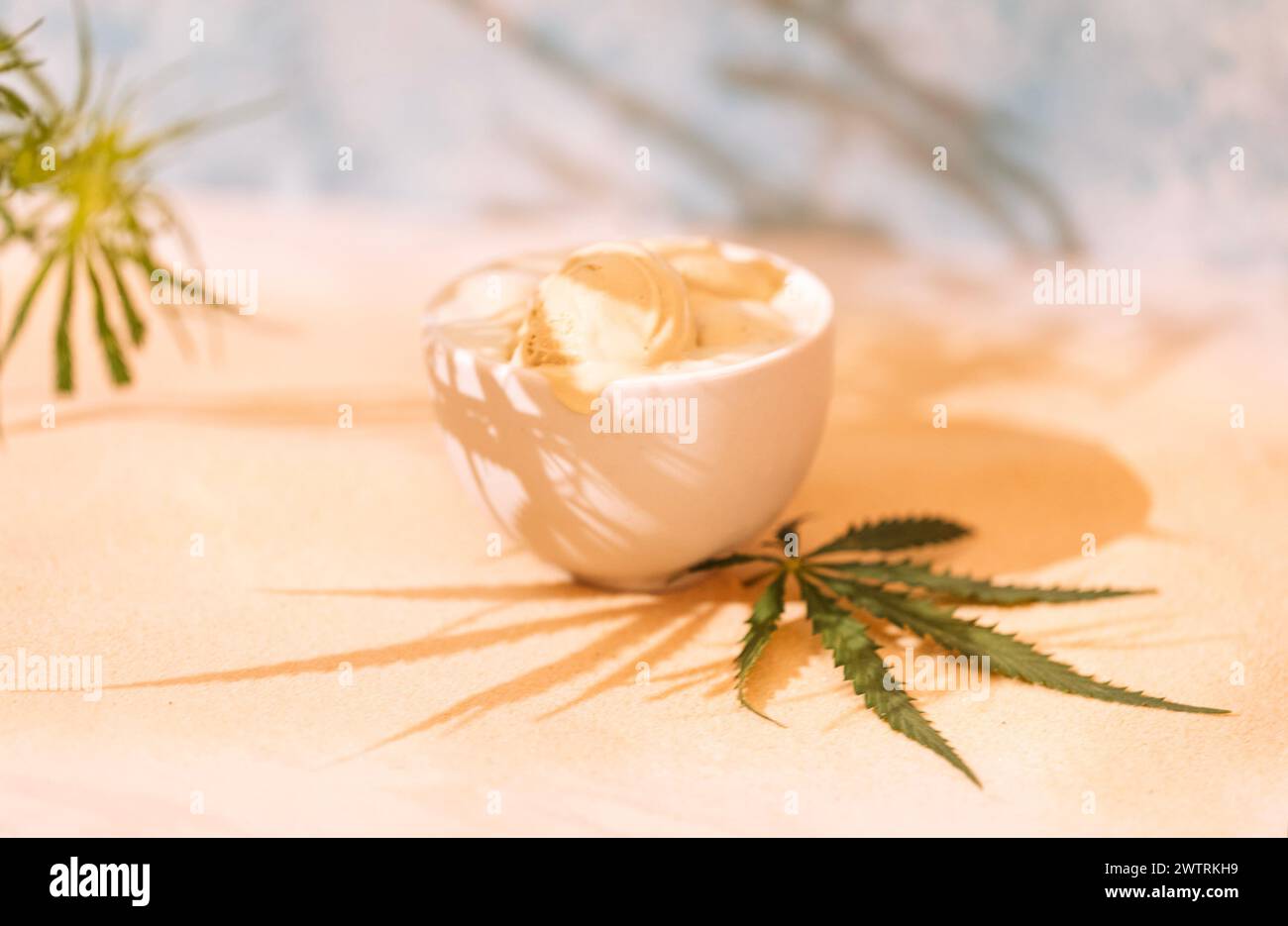 A white ceramic bowl with delicious ice cream and a cannabis leaf. A ...