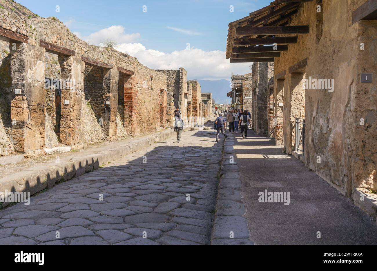 Pompeii Italy, Street in ancient Pompeii, paved during Roman times with ...