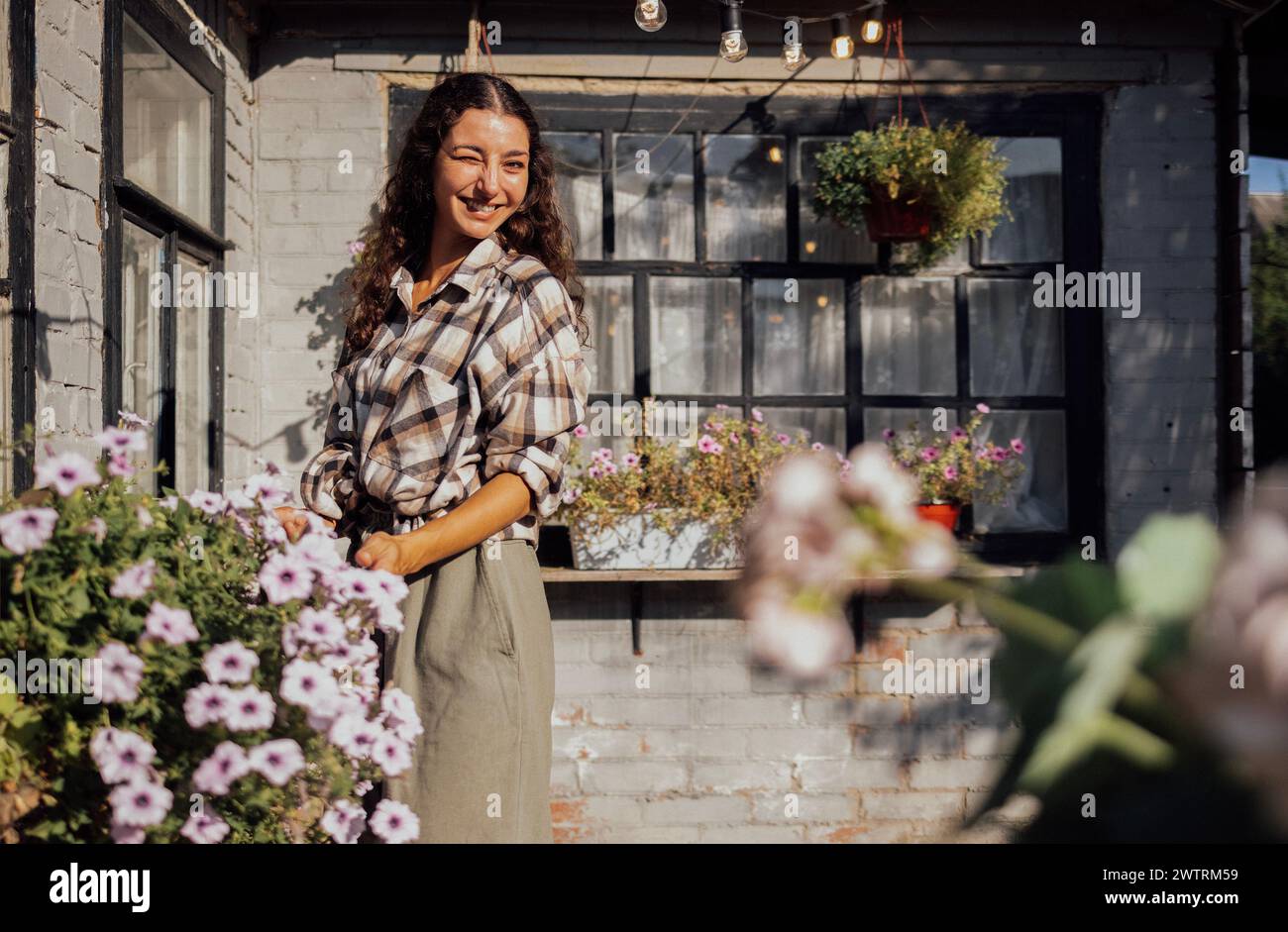 Portrait of a young charming woman in casual clothes winking and ...