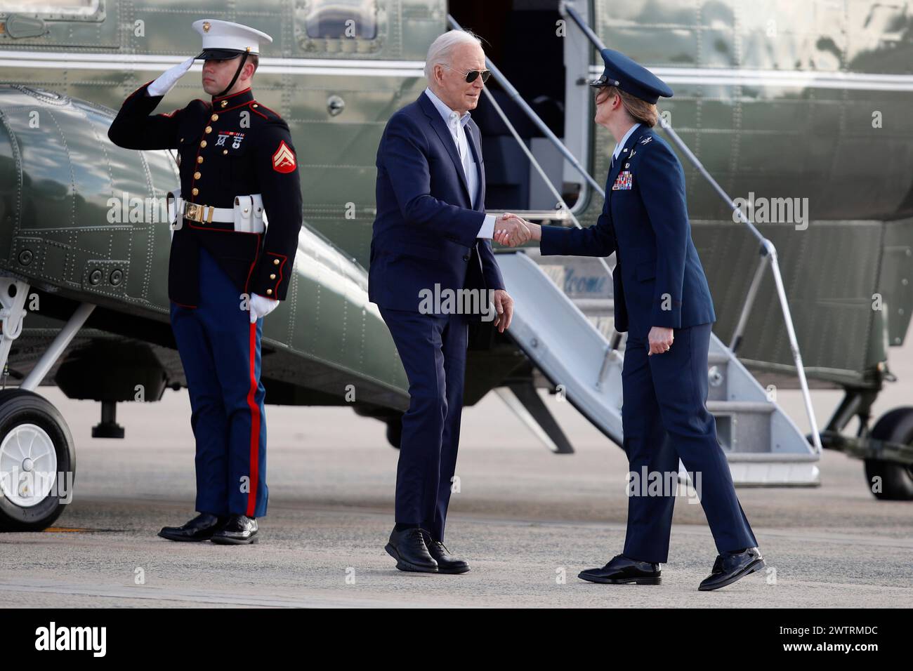 President Joe Biden, is greeted by Air Force Col. Angela Ochoa ...