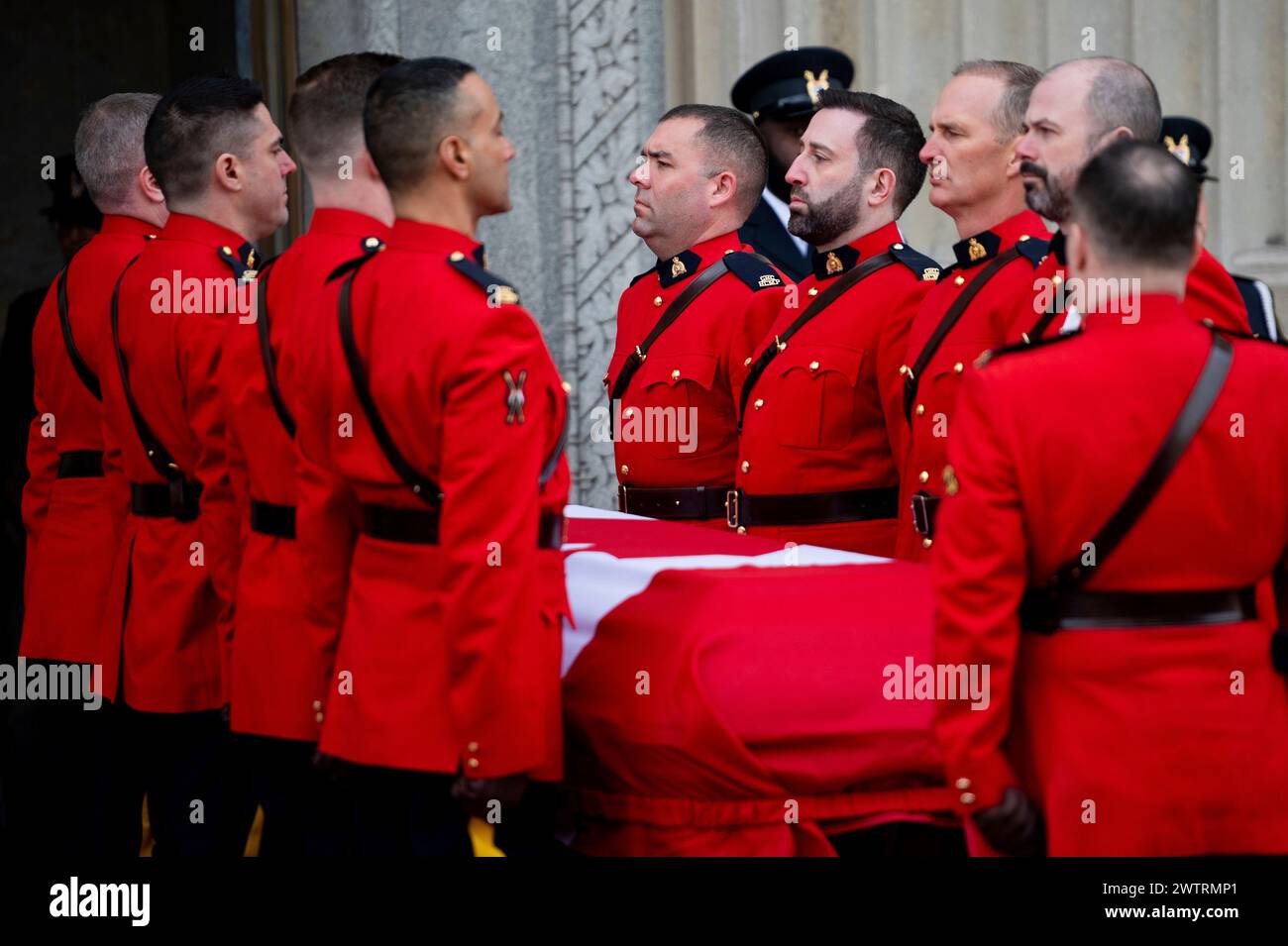 Members of the Royal Canadian Mounted Police (RCMP) stand at attention ...