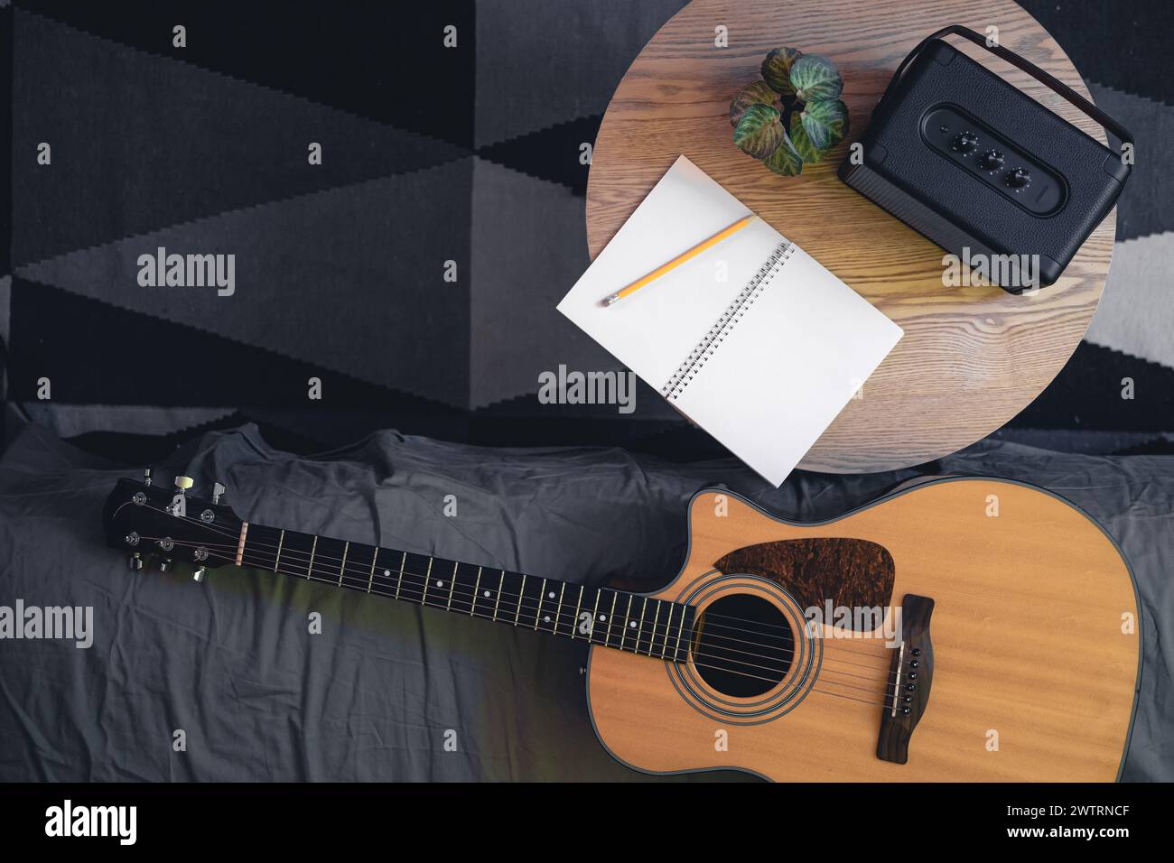 Musical background with acoustic guitar, speaker and notepad on the ...