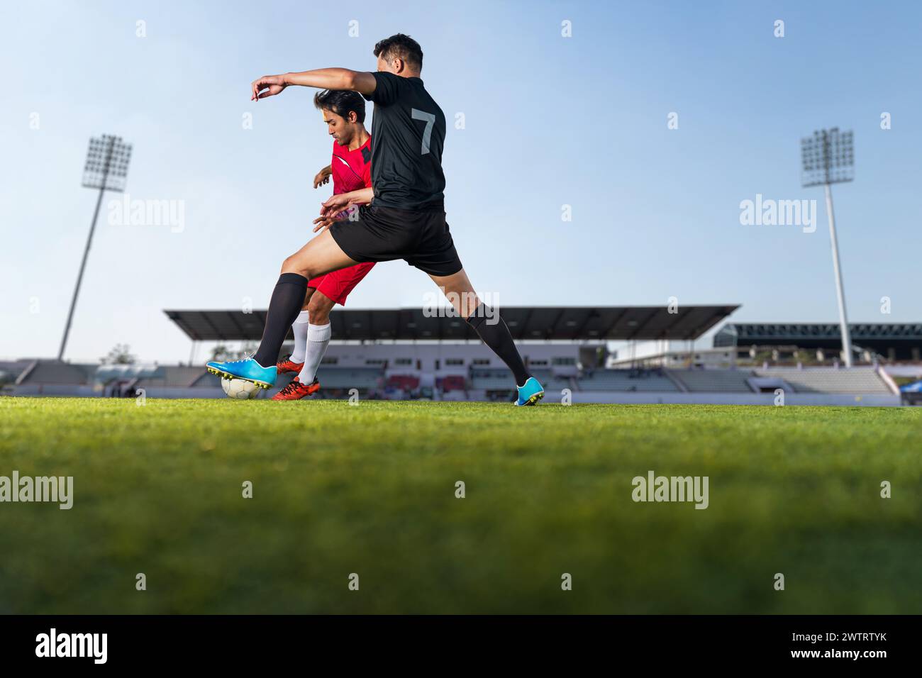 Football player playing ball in the outdoor soccer field stadium Stock ...