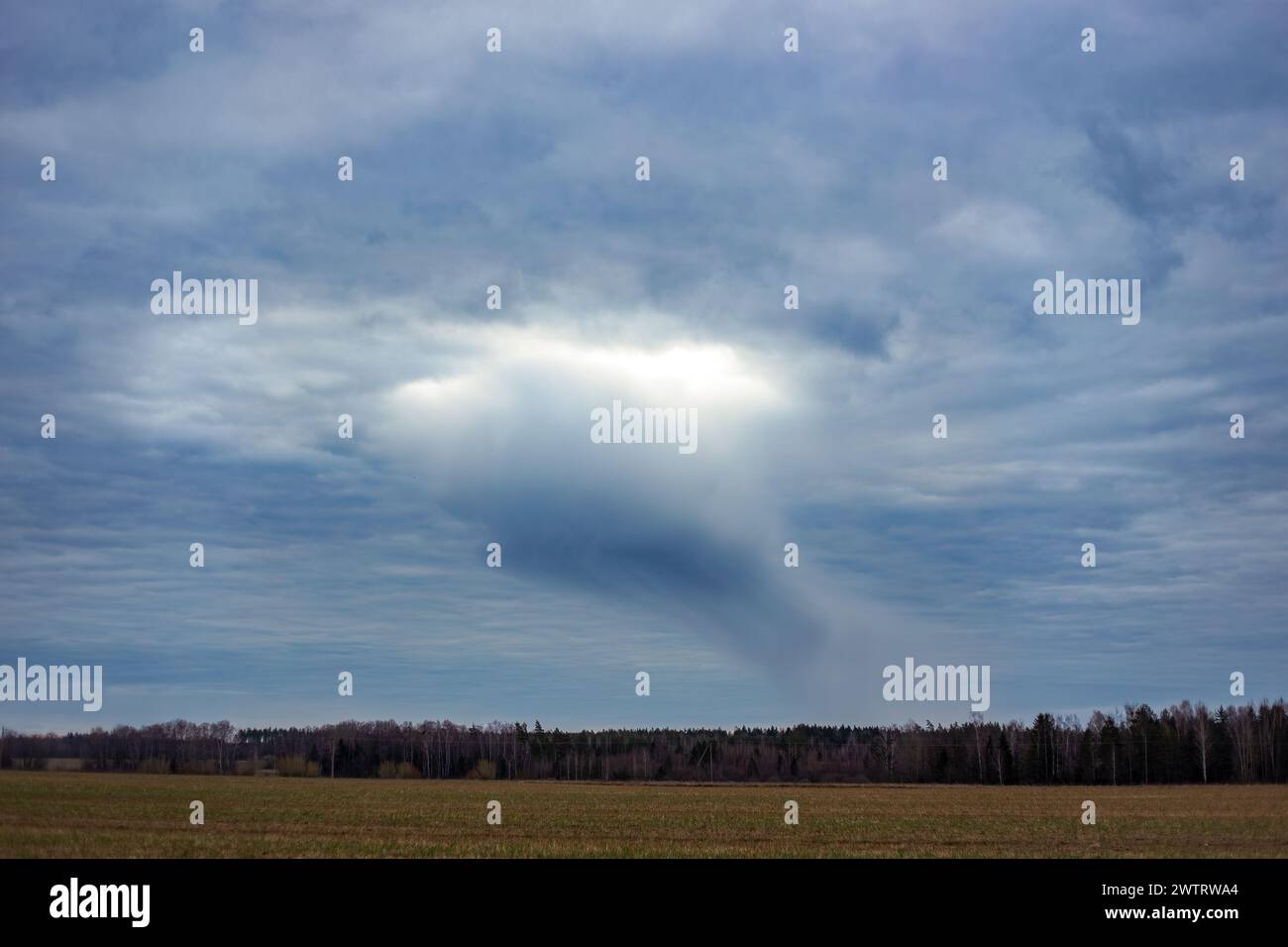 Light but oddly shaped cloud, no rain, spring Stock Photo - Alamy