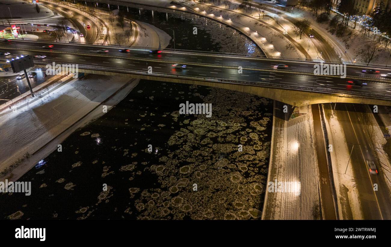 Drone photography of iced up river, bridge and cars driving during ...