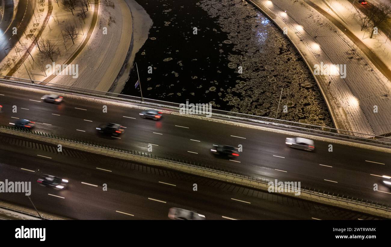 Drone photography of iced up river, bridge and cars driving during ...