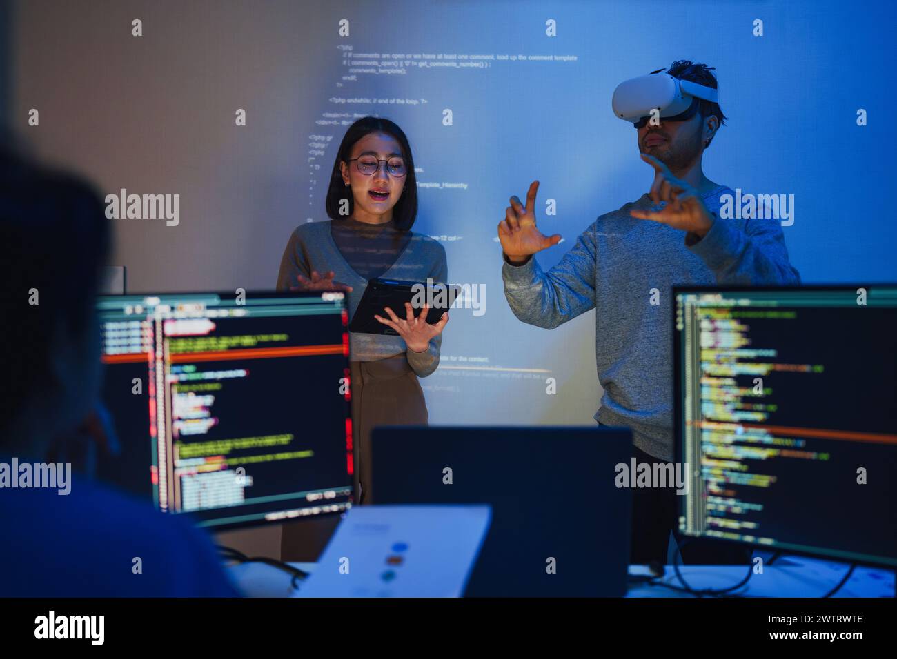 Asian And Indian Developer Team Brainstorming And Presentation About Virtual Reality With Ai