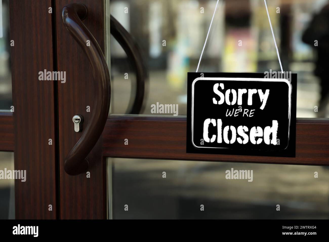 Sorry we are closed sign hanging on glass door Stock Photo - Alamy