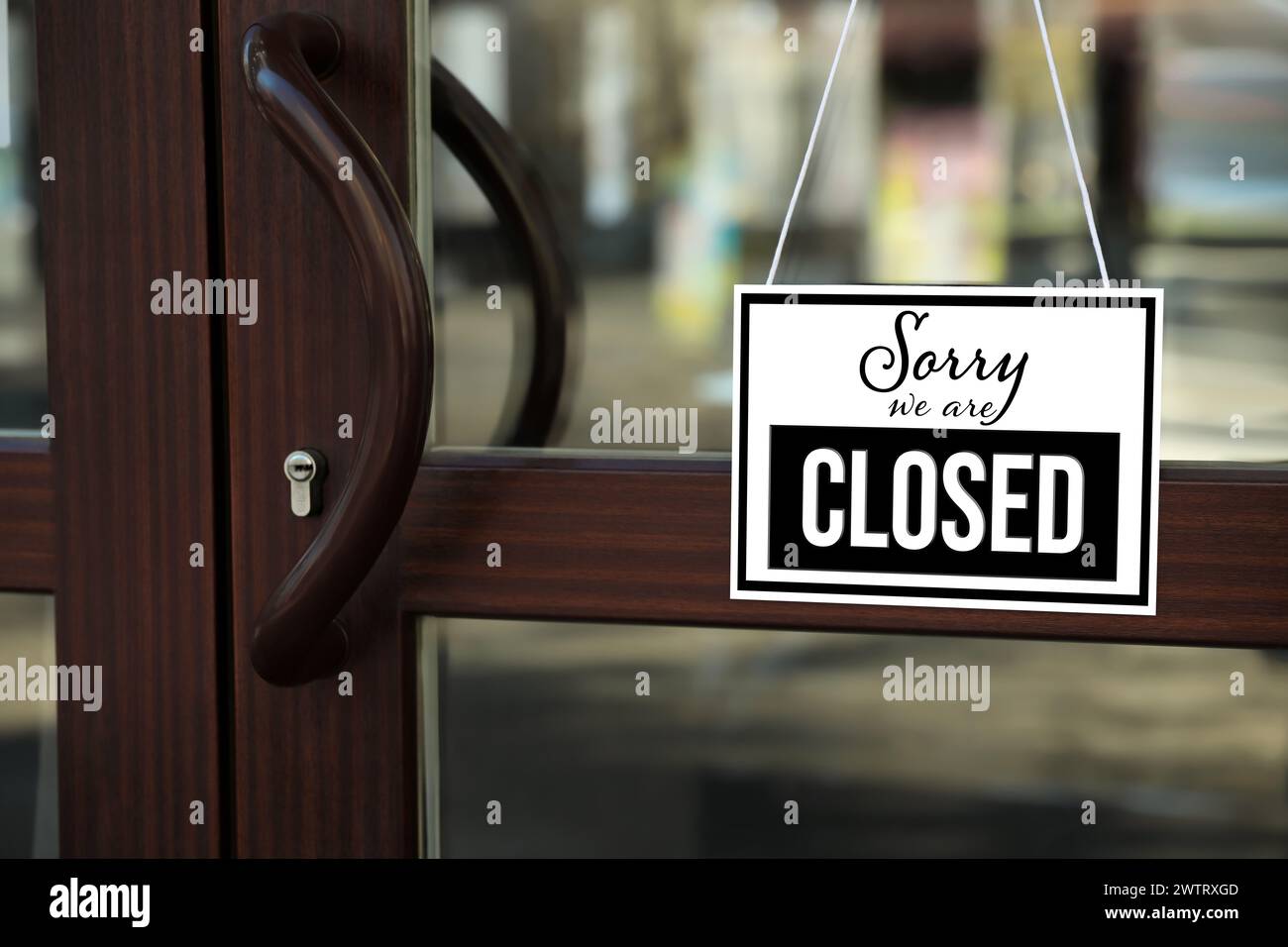 Sorry we are closed sign hanging on glass door Stock Photo - Alamy