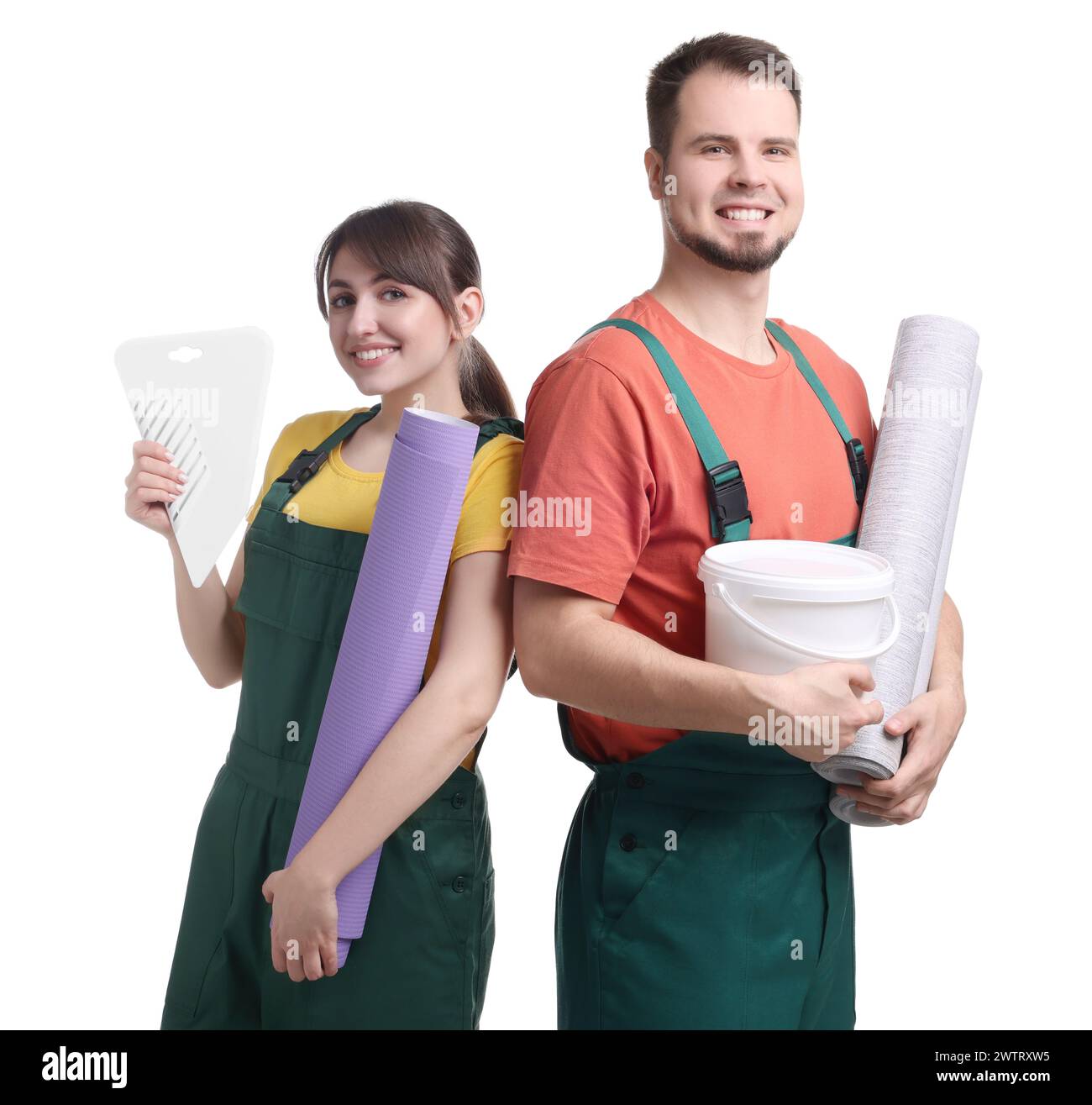 Workers with wallpaper rolls, bucket of glue and spatula on white ...