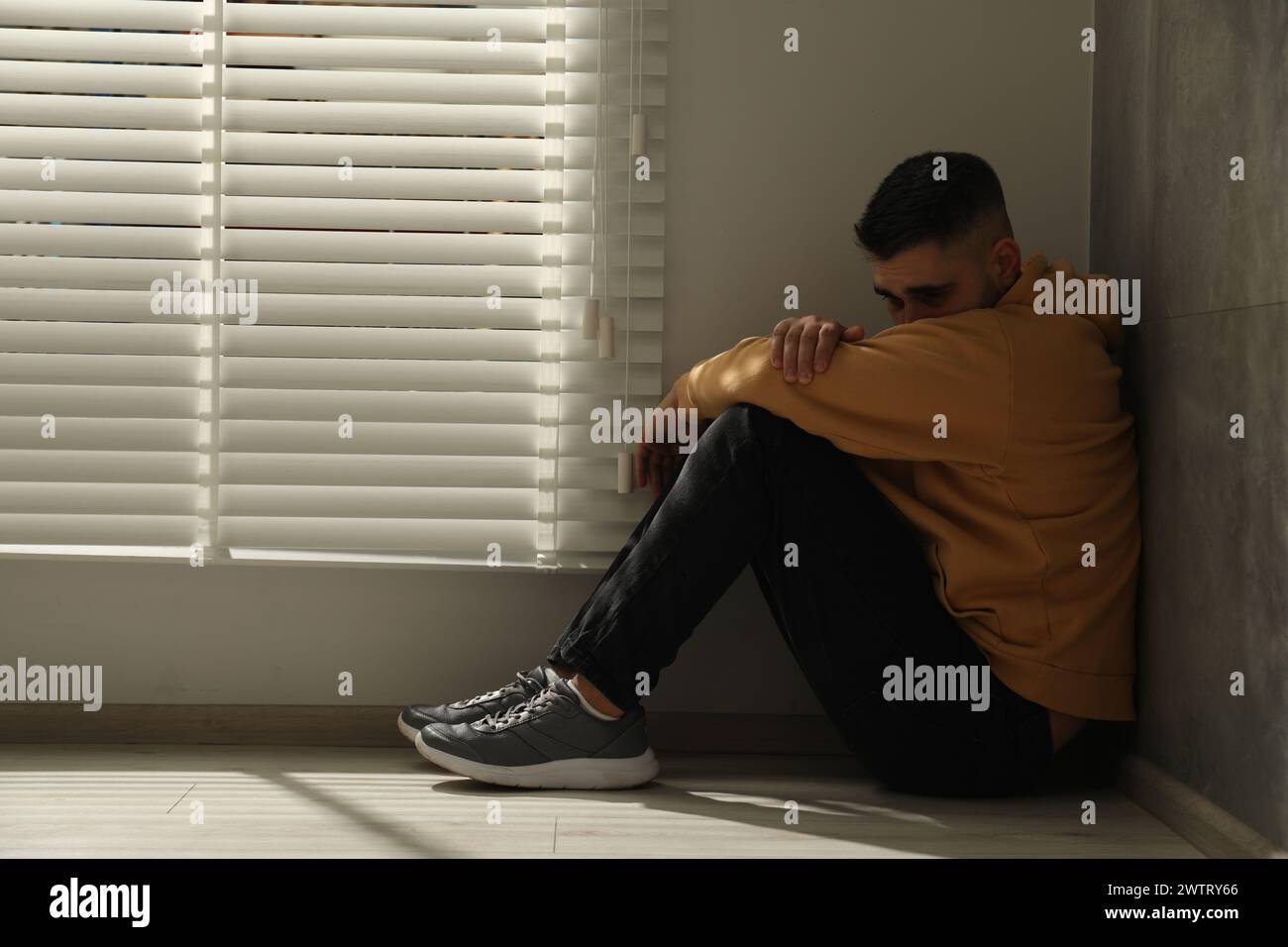 Man crying sitting on floor hi-res stock photography and images - Alamy